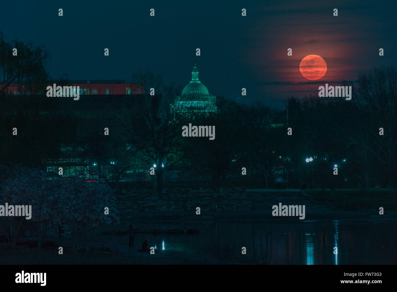 The full moon rises over the United States Capitol Building Stock Photo ...