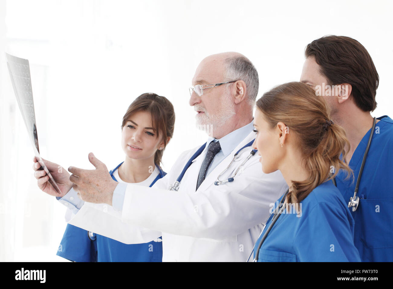 Medical team checking on X-ray results isolated on white Stock Photo ...