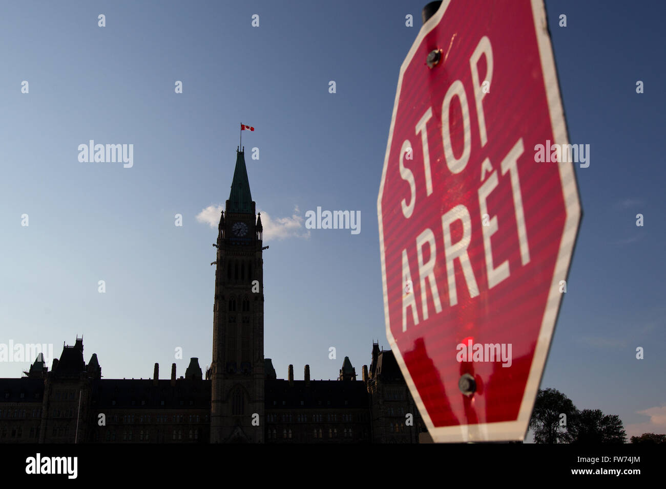 A stop sign sits in front of Centre block on Parliament Hill in Ottawa ...
