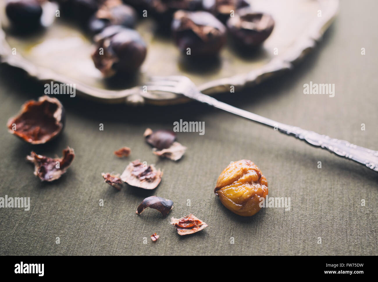 Roasted chestnuts on an old gold plate Stock Photo - Alamy