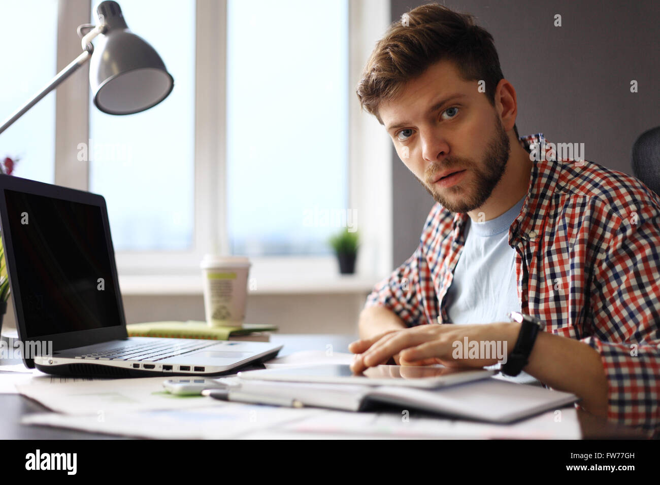 Confident young man work place hi-res stock photography and images - Alamy