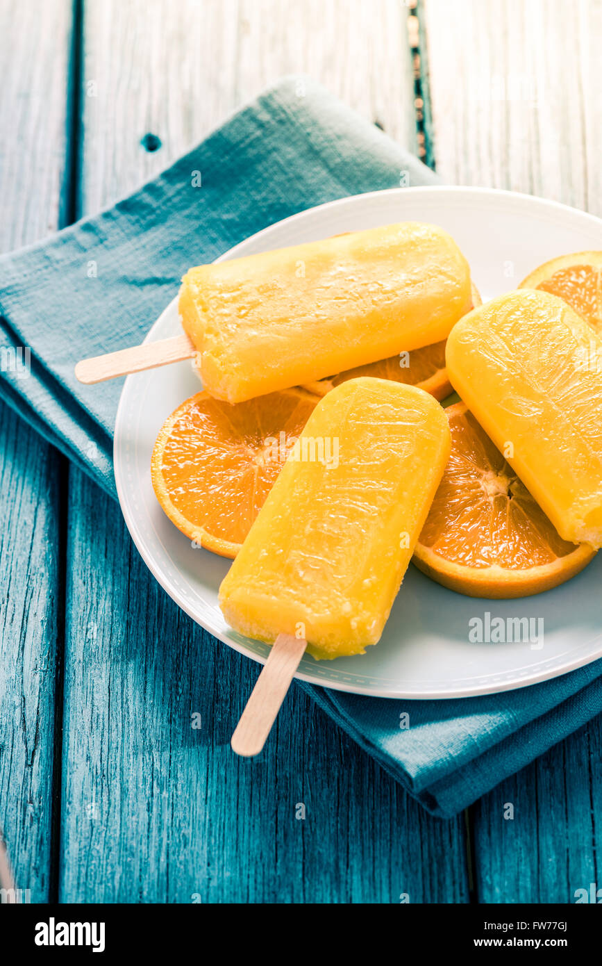 homemade tasty popsicle with fresh orange, vibrant blue and orange ...