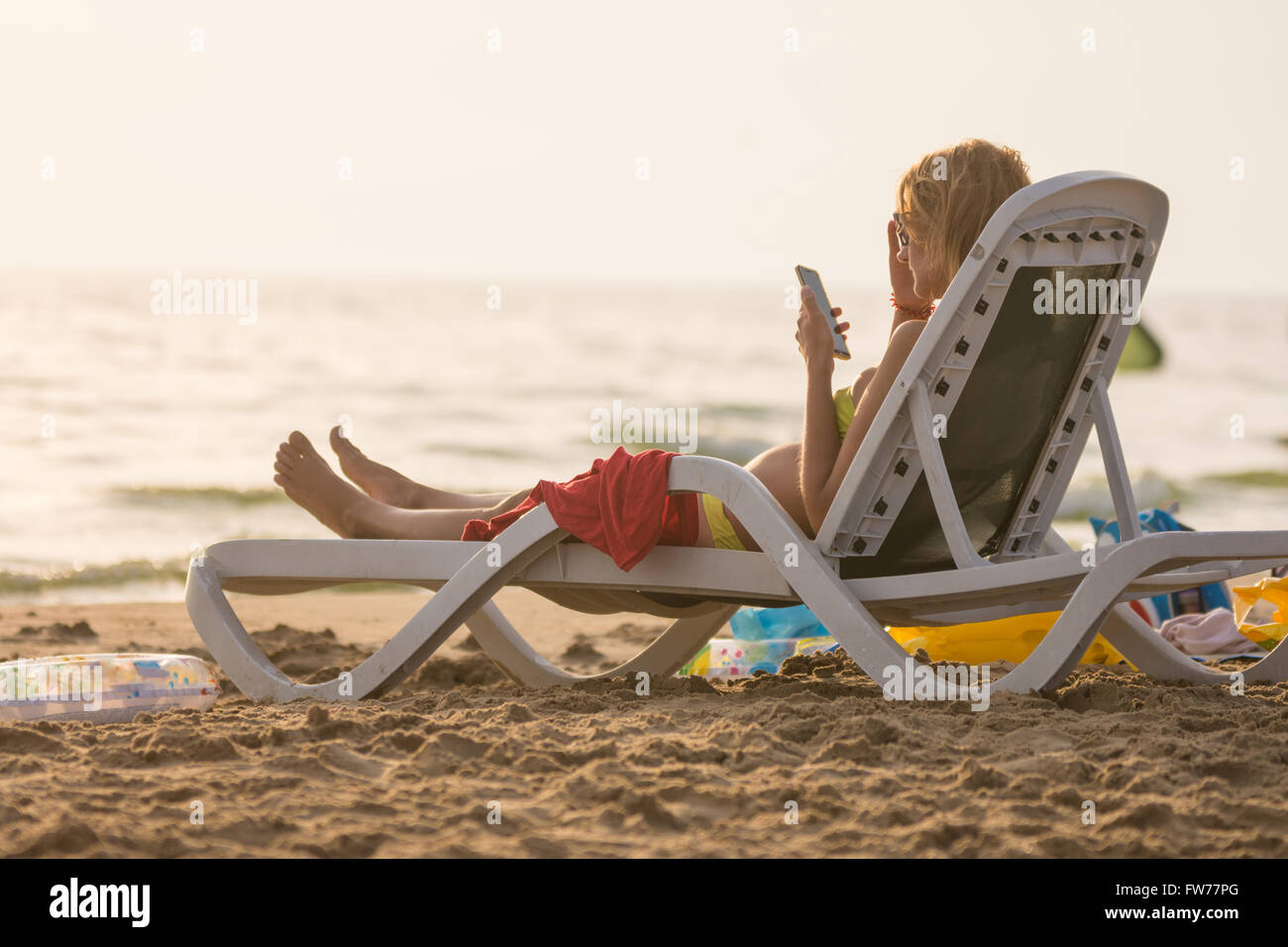 Woman lying on sun lounger hi-res stock photography and images - Alamy