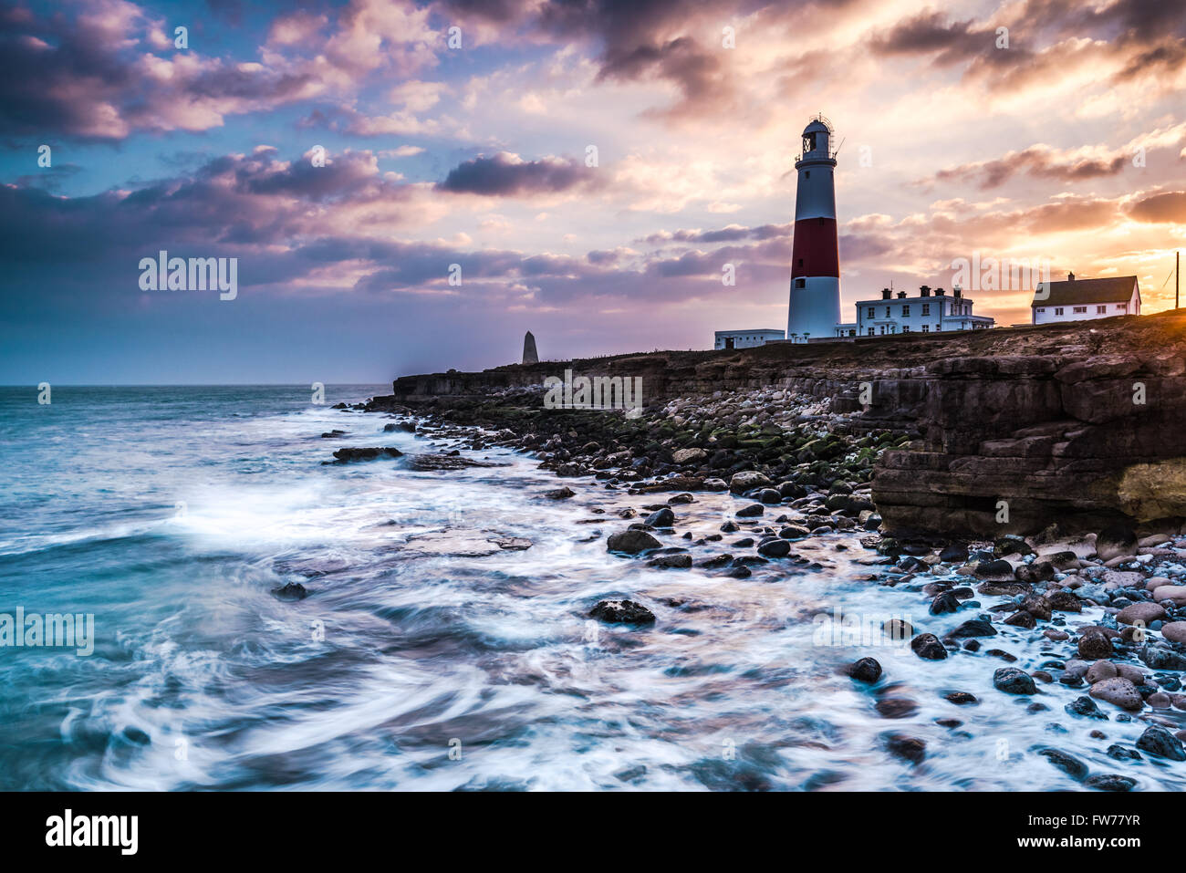 Time lapse sunset on coast with lighthouse on cliffs in Portland ...