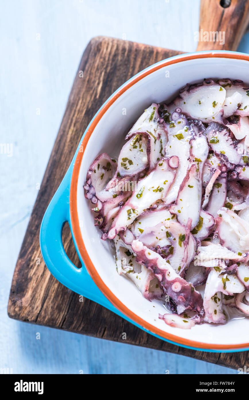 Octopus capraccio in traditional tapas ceramic bowl, from overhead on ...