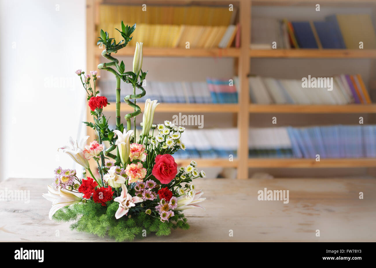 flower arrangement and bookshelf Stock Photo - Alamy