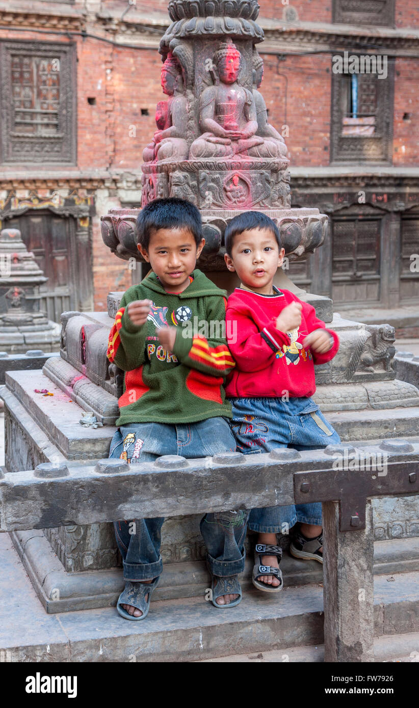 Bhaktapur, Nepal. Two Young Boys Sitting by a Buddhist Shrine Stock ...