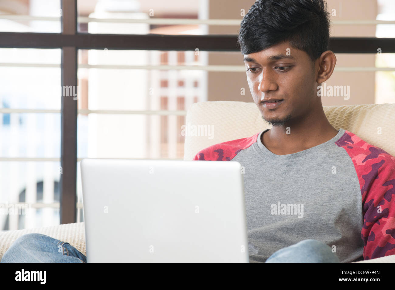 indian male teenager using laptop Stock Photo - Alamy