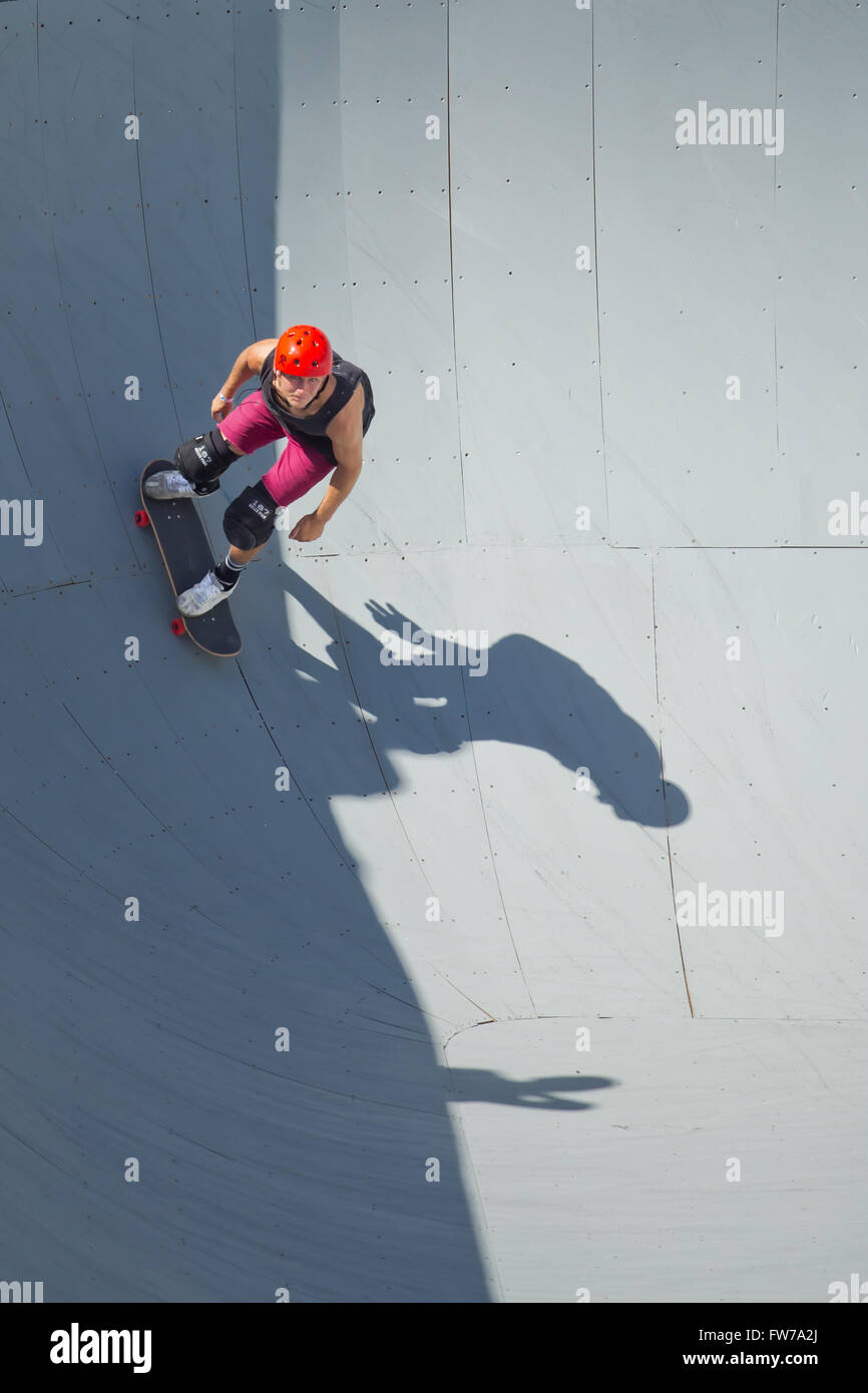 A professional skateboarder performs his tricks in a tournament Stock ...