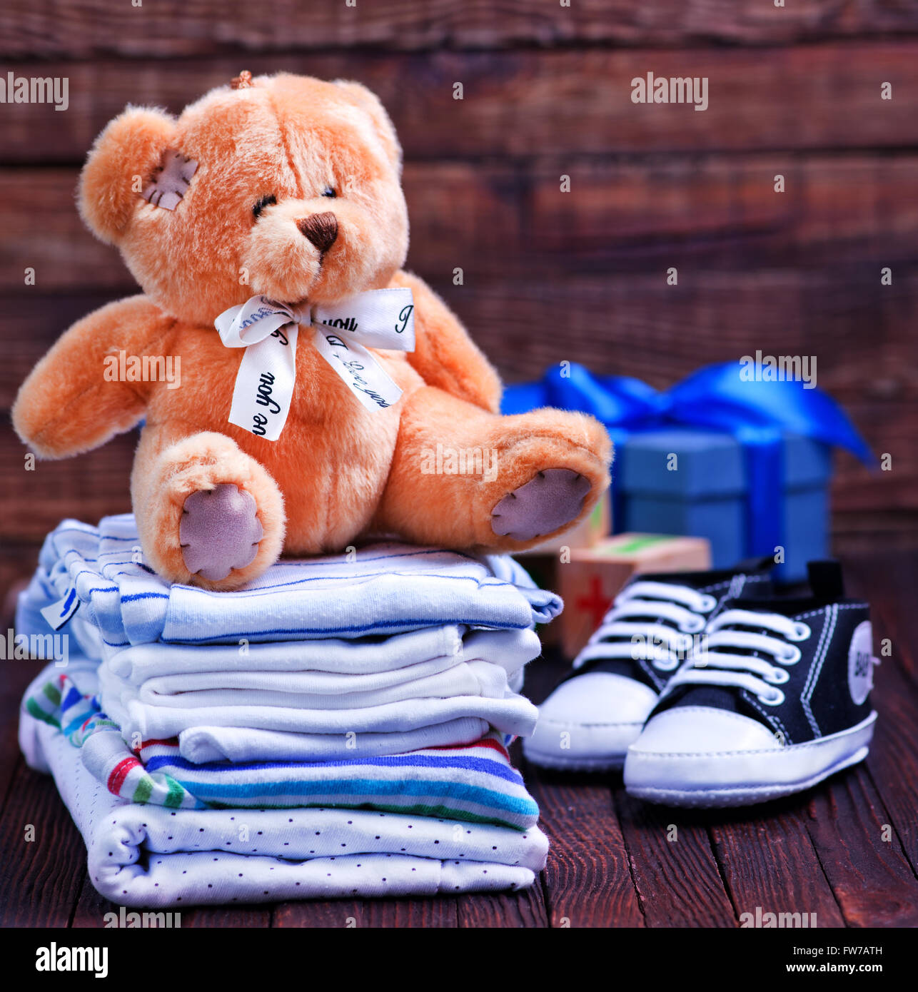 Clear baby clothes on the wooden table Stock Photo - Alamy