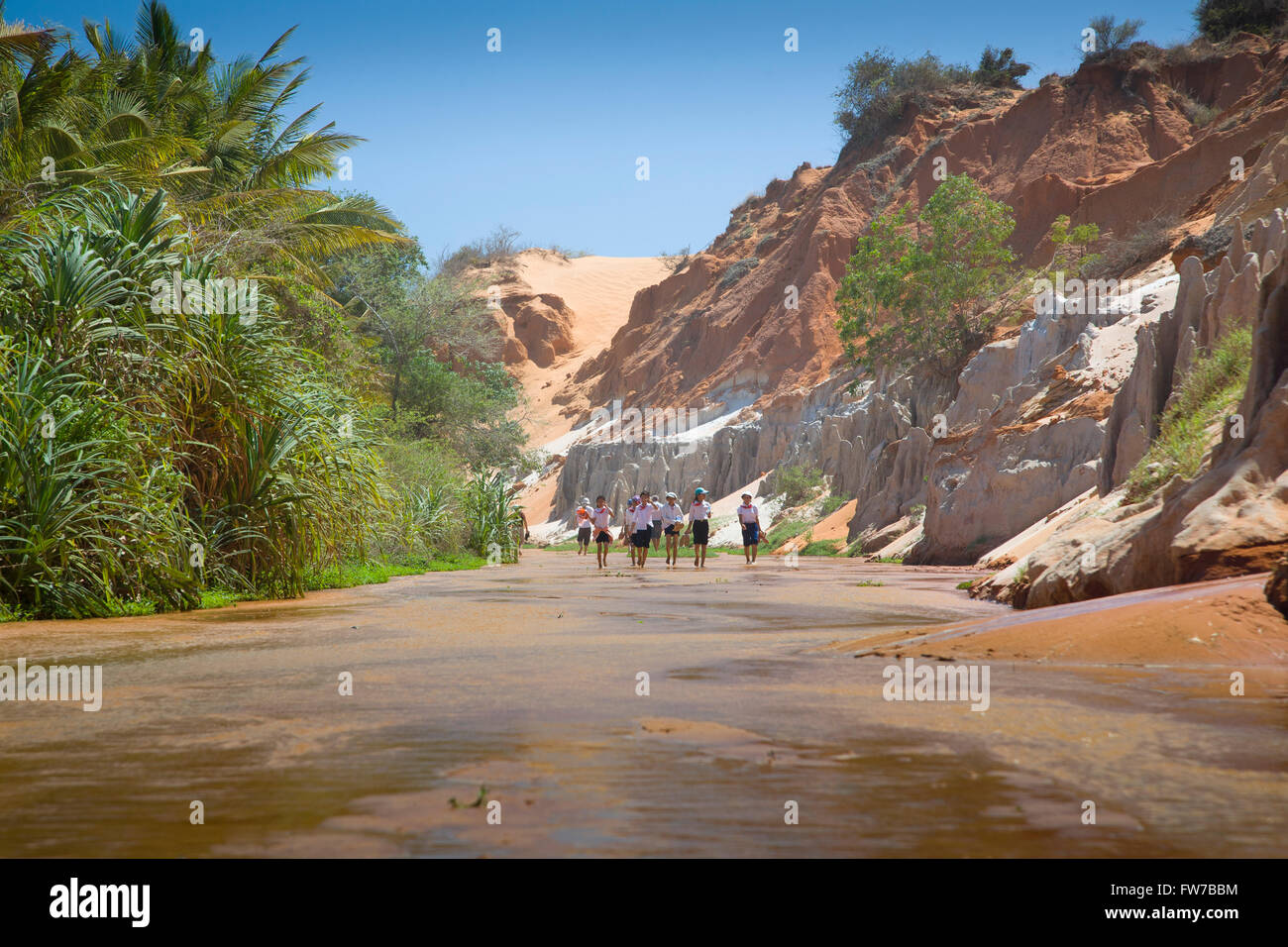 Vietnamese school girls walking along the fairy stream in Mui Ne ...