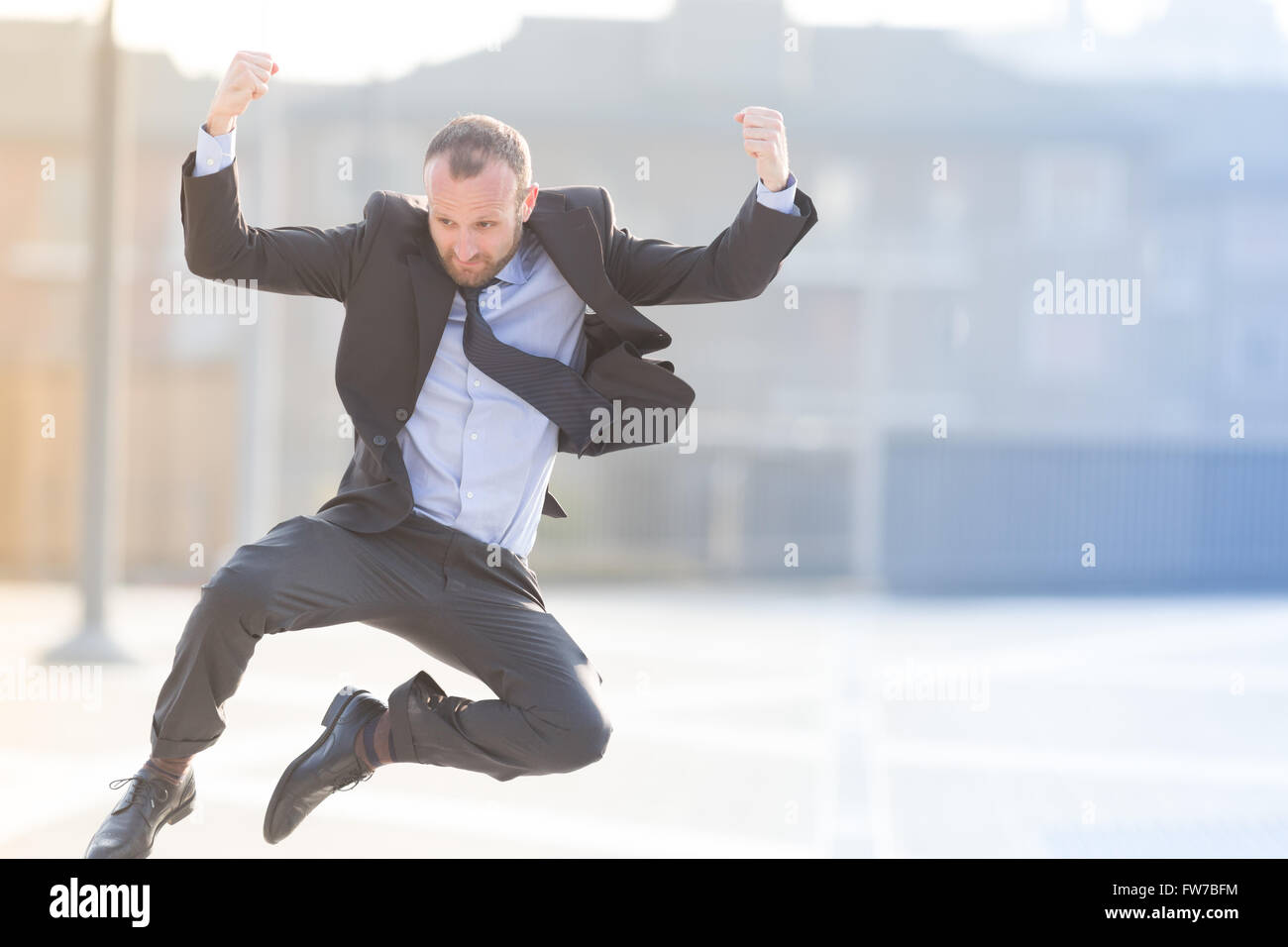 Dynamic businessman jumping outdoor in the city Stock Photo - Alamy