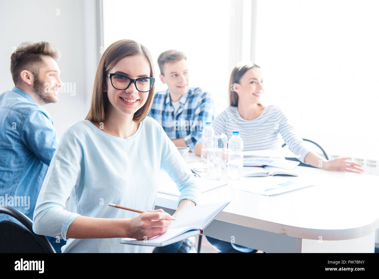 Cheerful girl making notes Stock Photo - Alamy