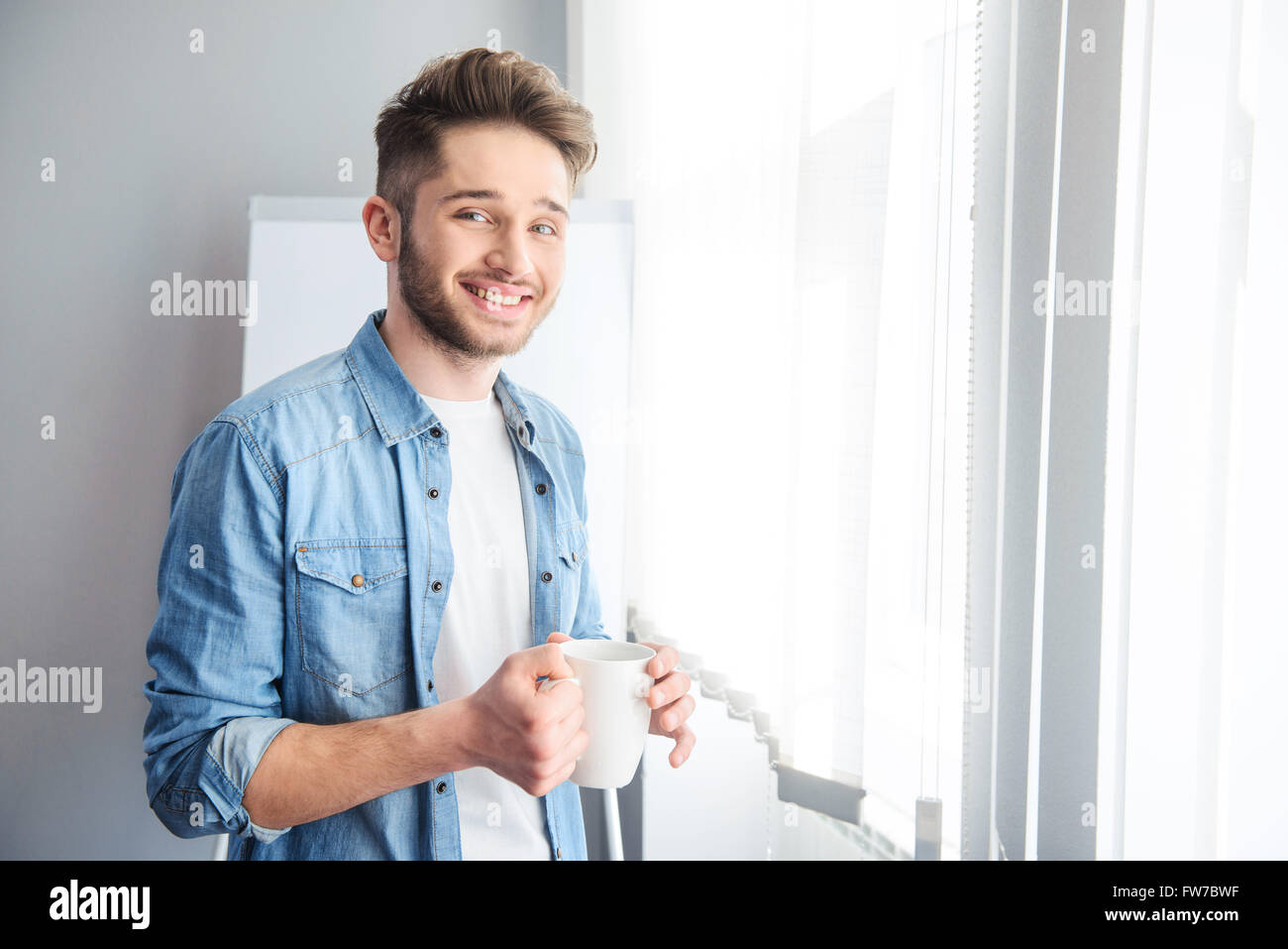 Handsome man drinking tea Stock Photo - Alamy