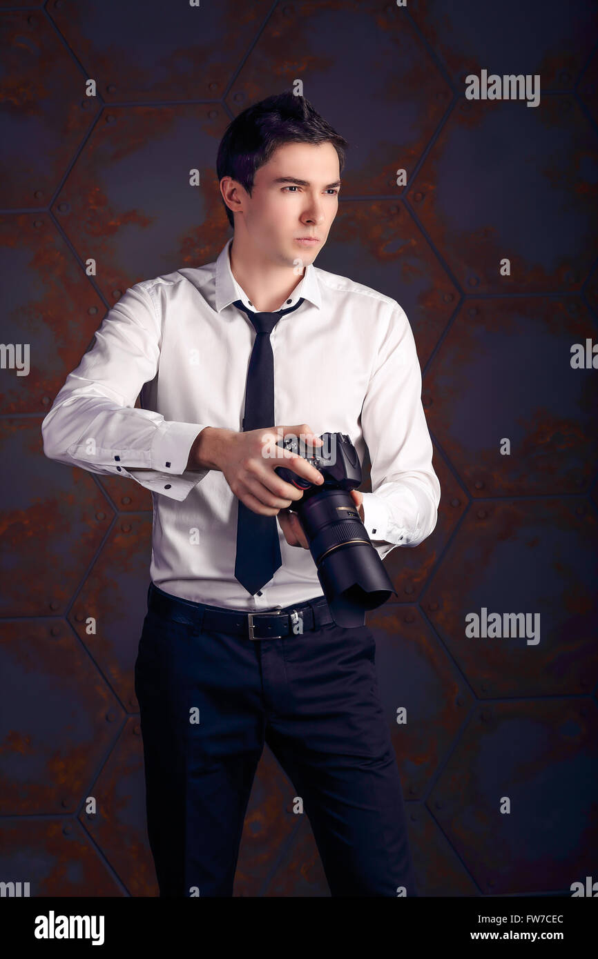 Photographer with camera in studio Stock Photo - Alamy