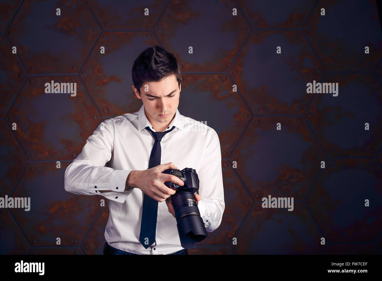 Photographer with camera in studio Stock Photo - Alamy
