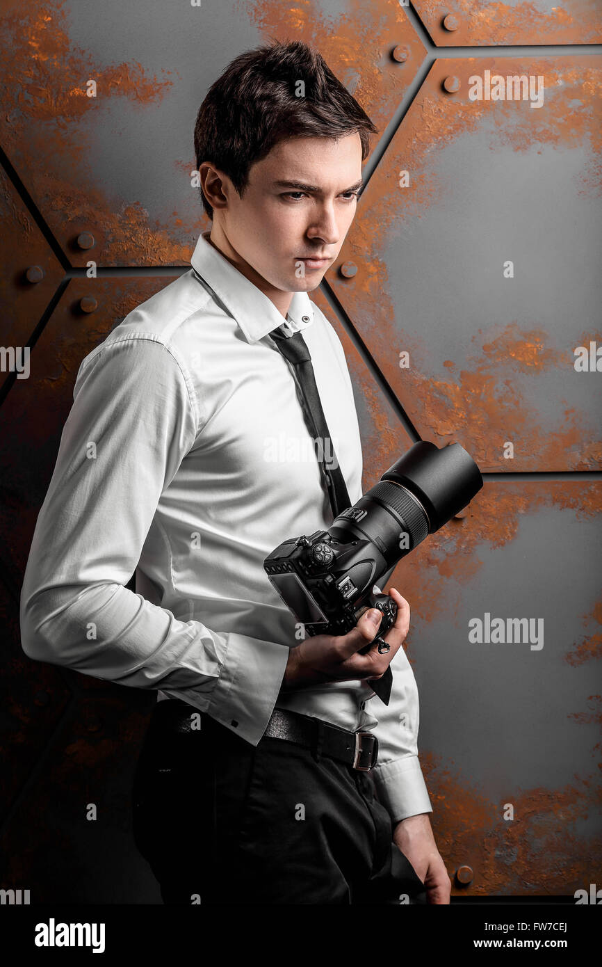 Photographer with camera in studio Stock Photo - Alamy