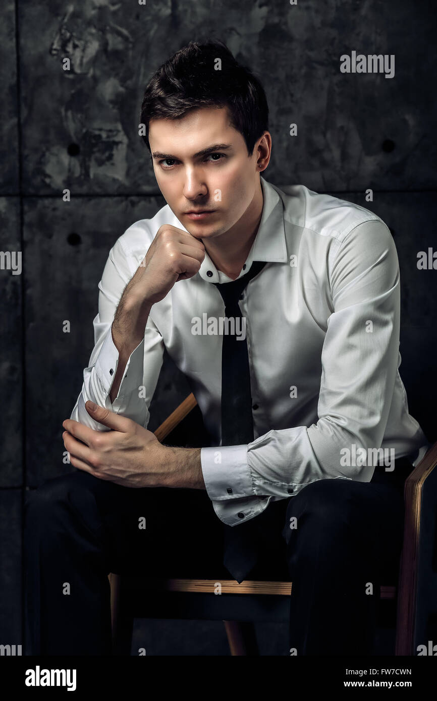 Successful businessman sitting on a chair Stock Photo - Alamy