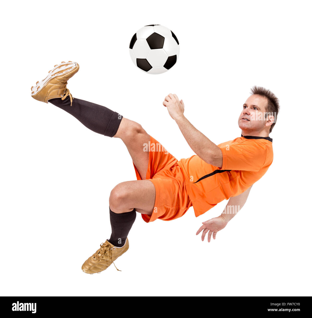 Soccer football player kicking the ball isolated on a white background ...