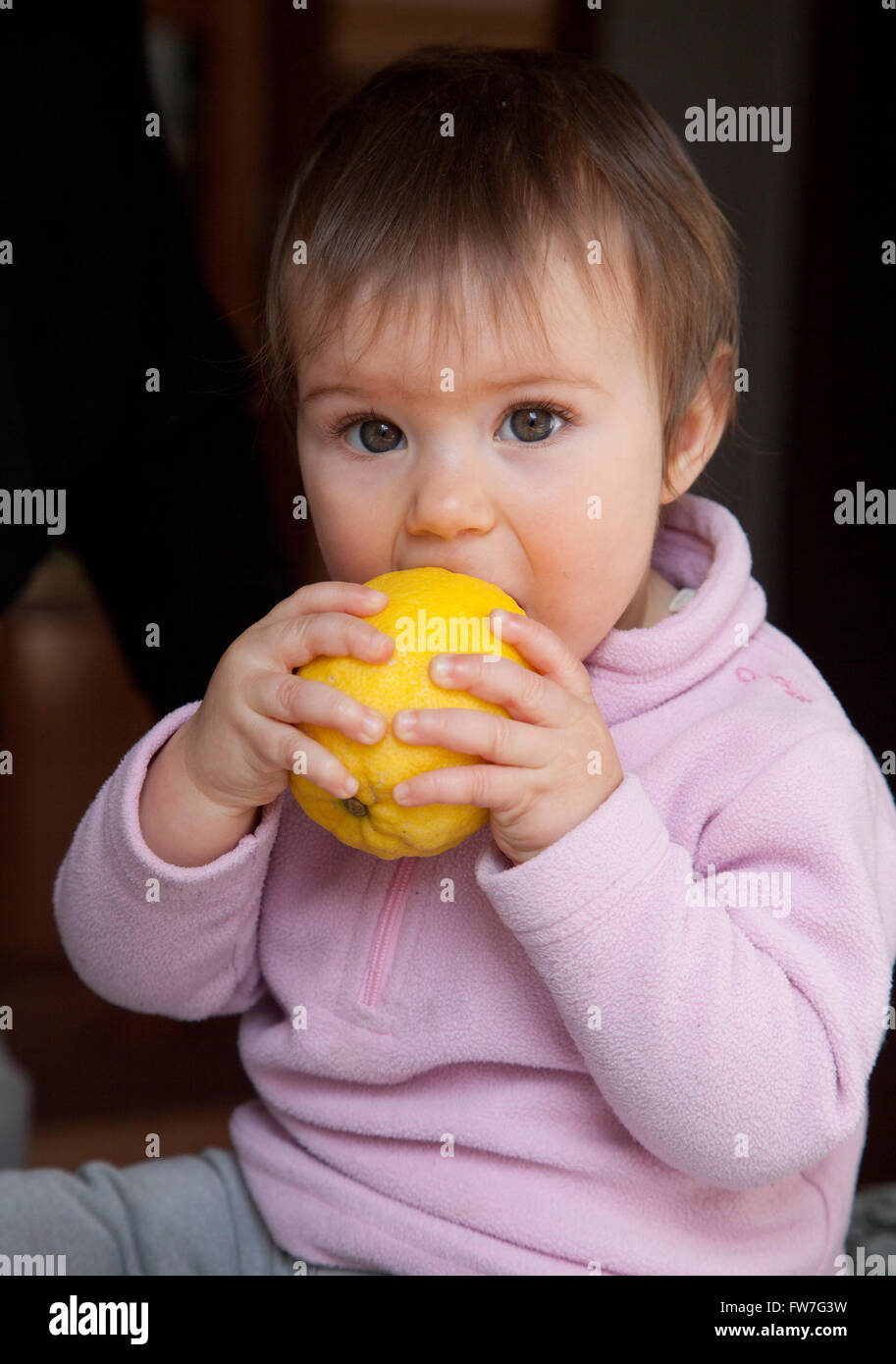 Baby Girl with fruit Stock Photo - Alamy