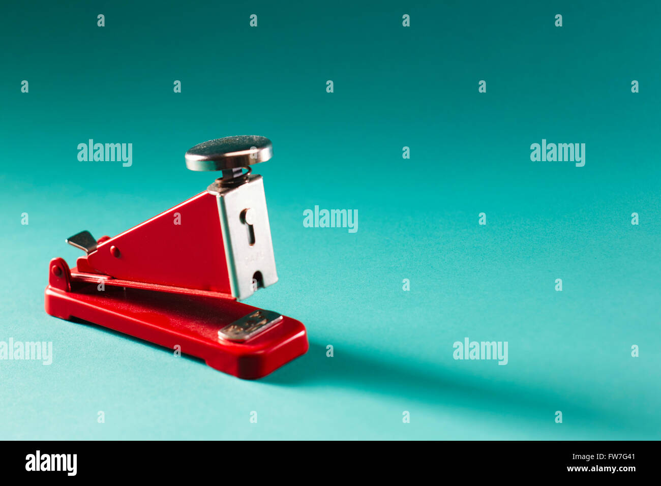 Folle stapler on mint background Stock Photo - Alamy