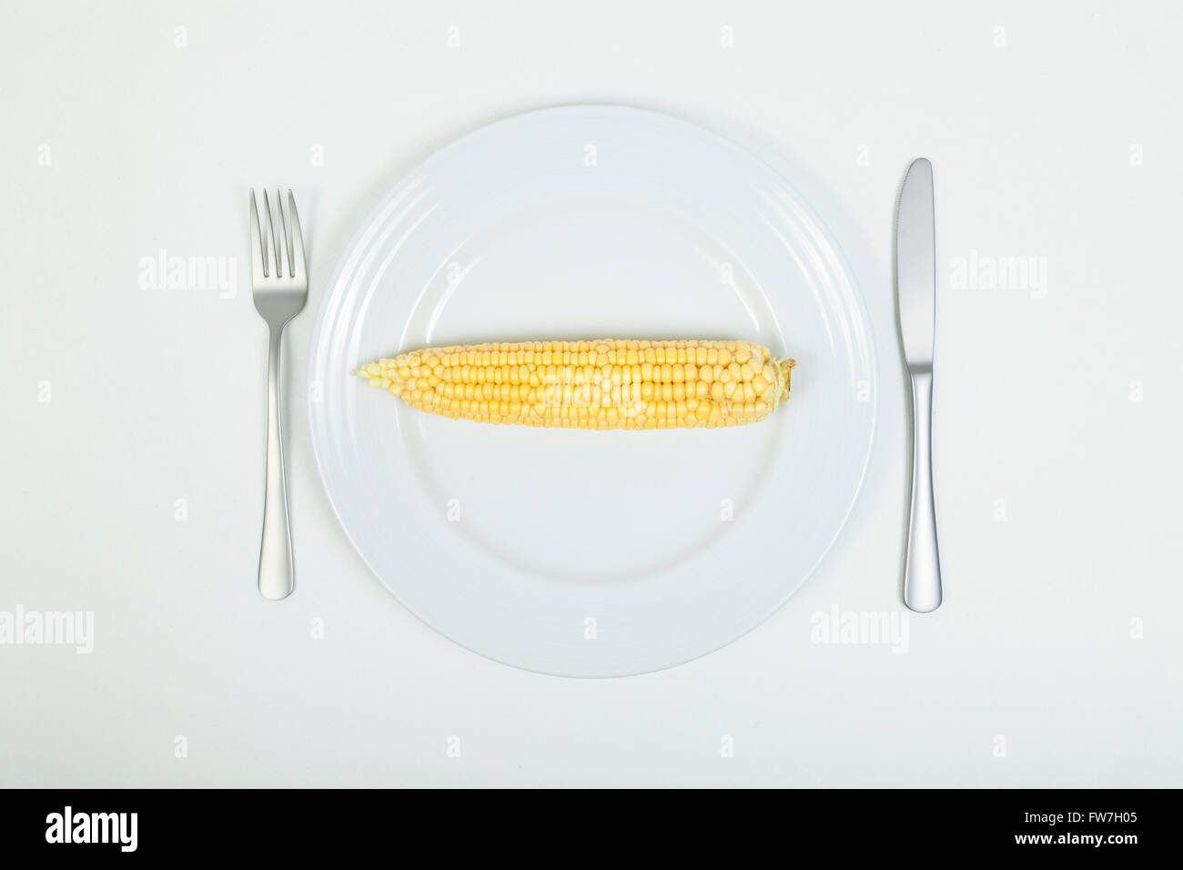 Corn cob on plate Stock Photo - Alamy