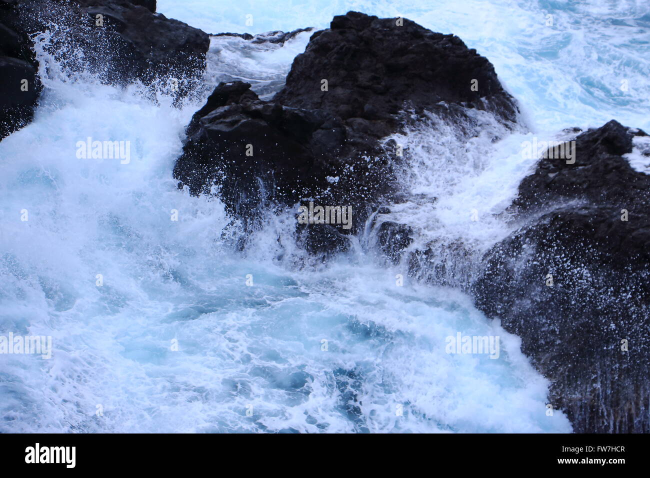 Ocean waves crashing over the volcanic rocks in Atlantic Ocean at ...