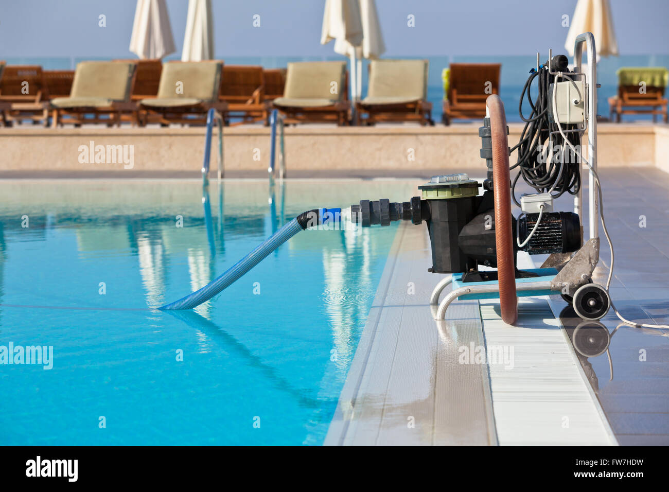 Cleaning pump working with a swimming pool. Horizontal shot Stock Photo ...