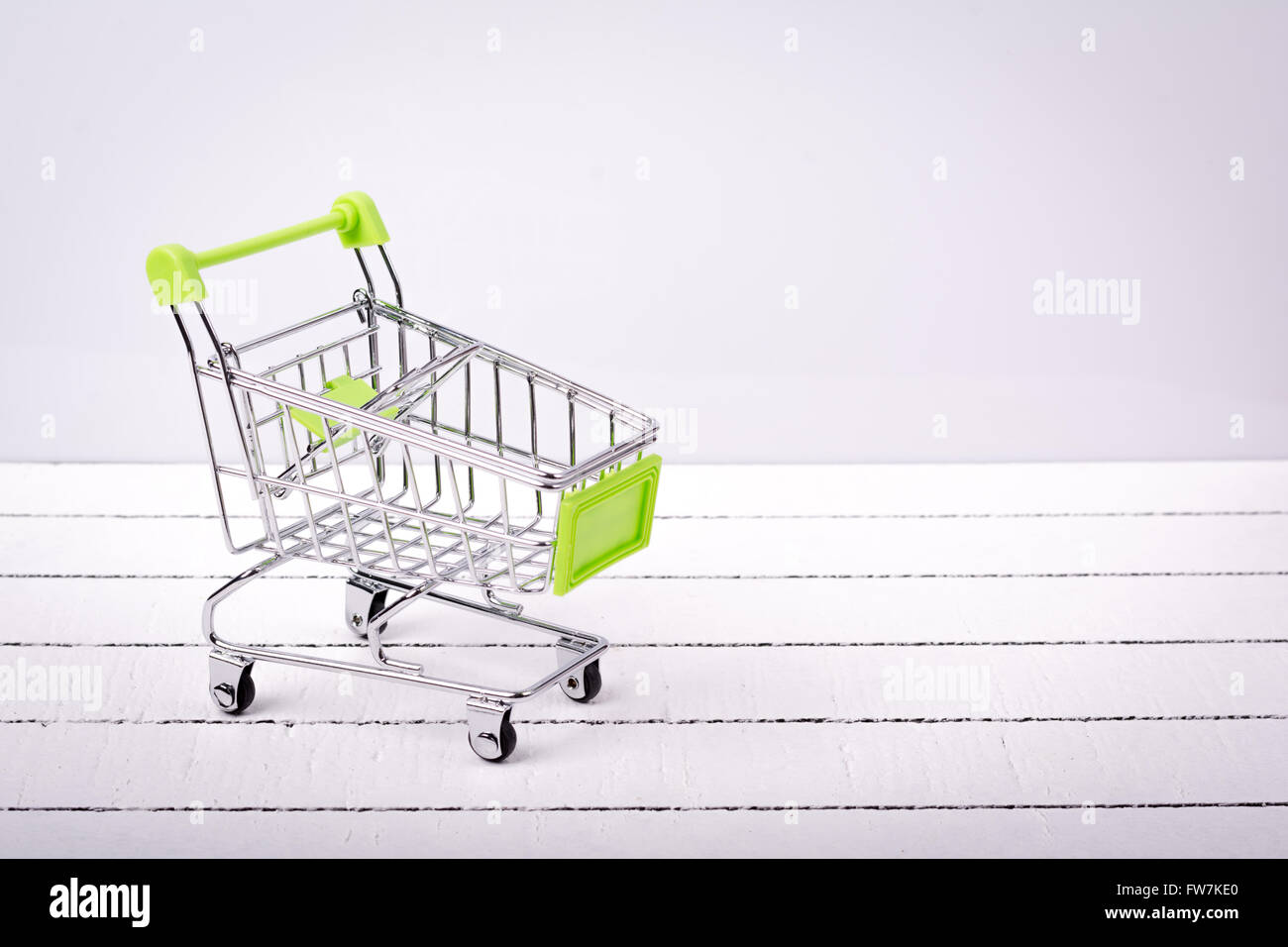 Small shopping cart on a white background Stock Photo - Alamy