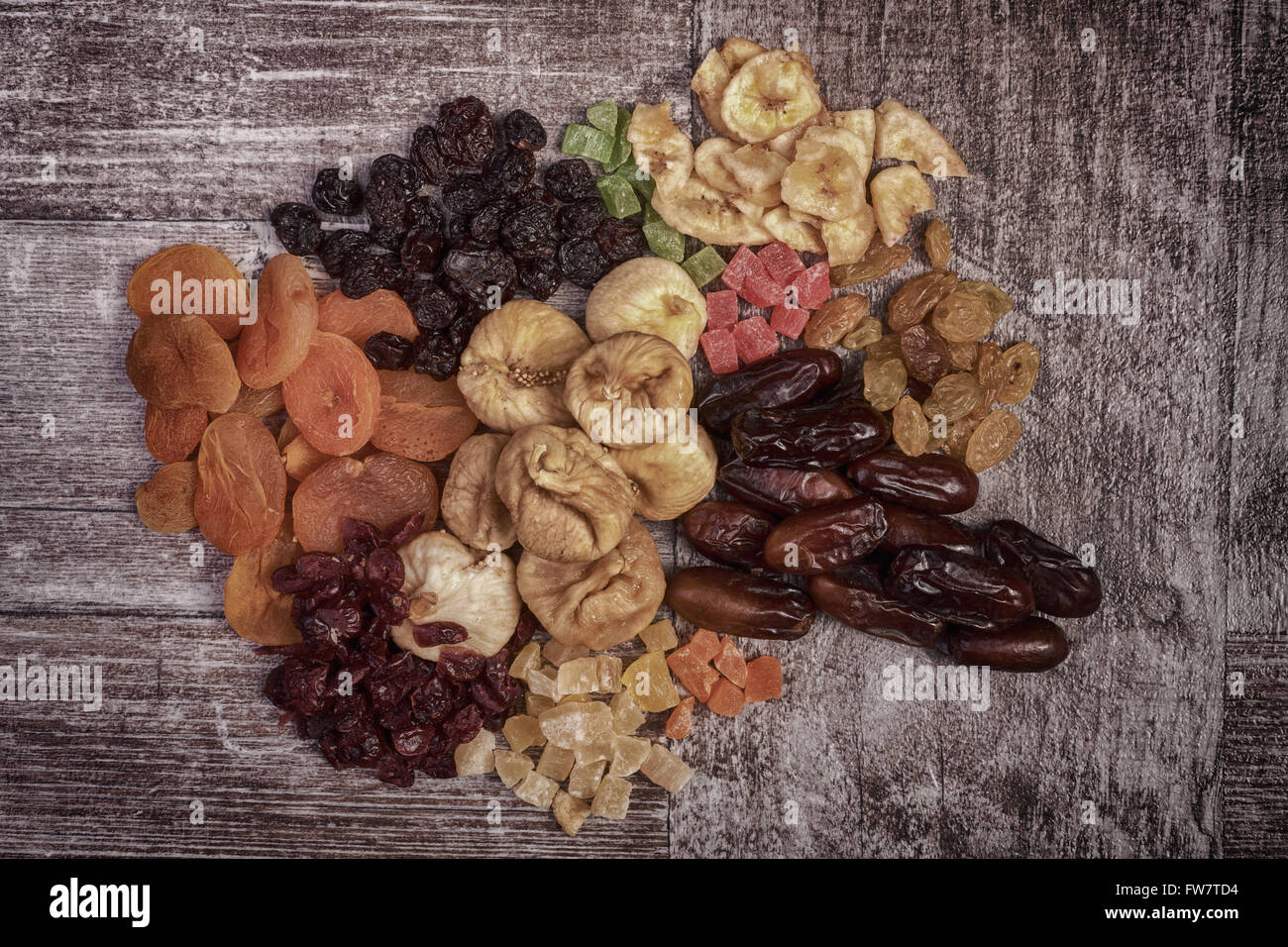 Different type of raw dried fruits on wooden type background in rich ...