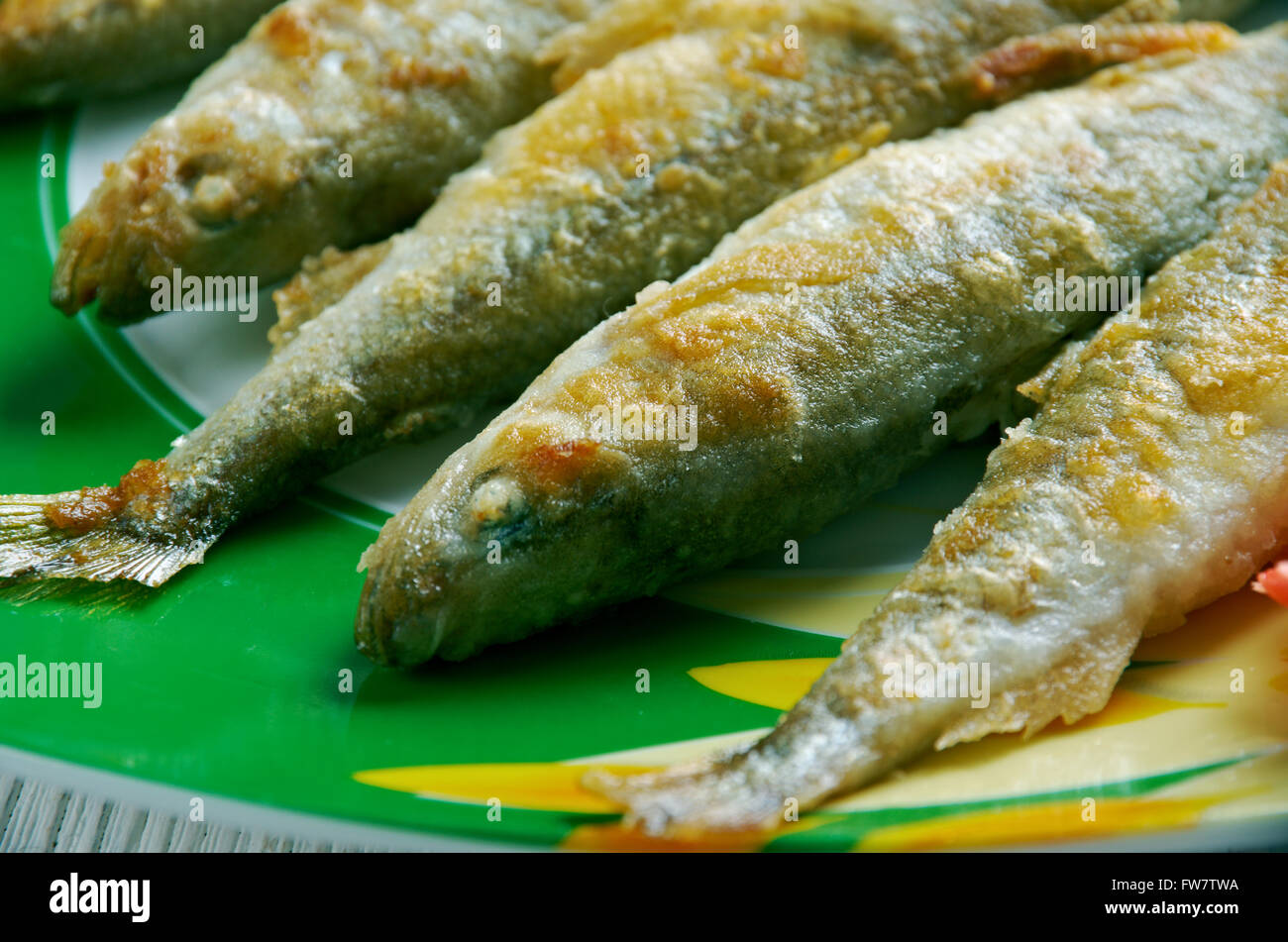 Roasted smelt fish on a plate.close up Stock Photo - Alamy