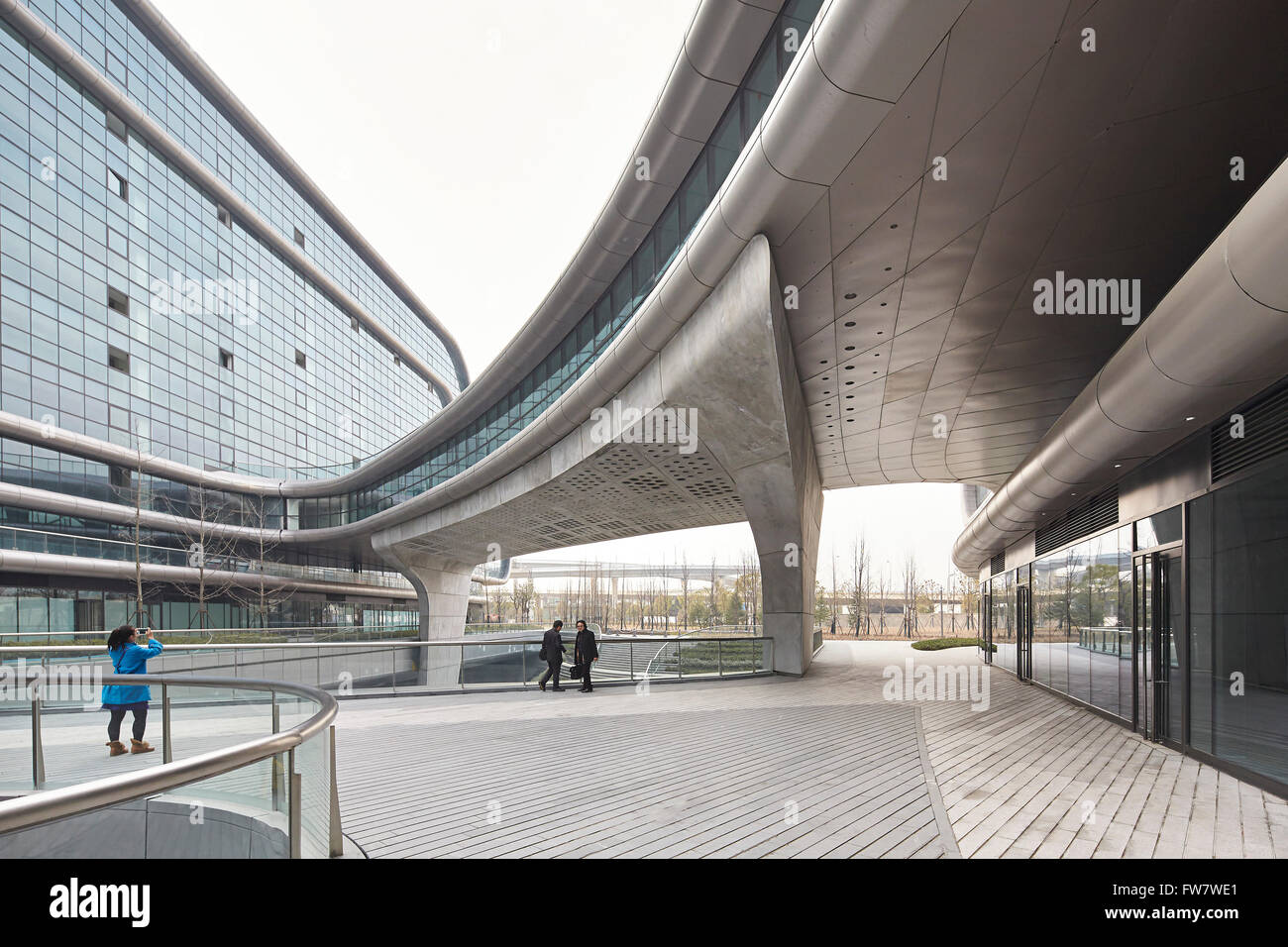 Exterior facade with landscaped walkways and bridge link. Sky SOHO ...