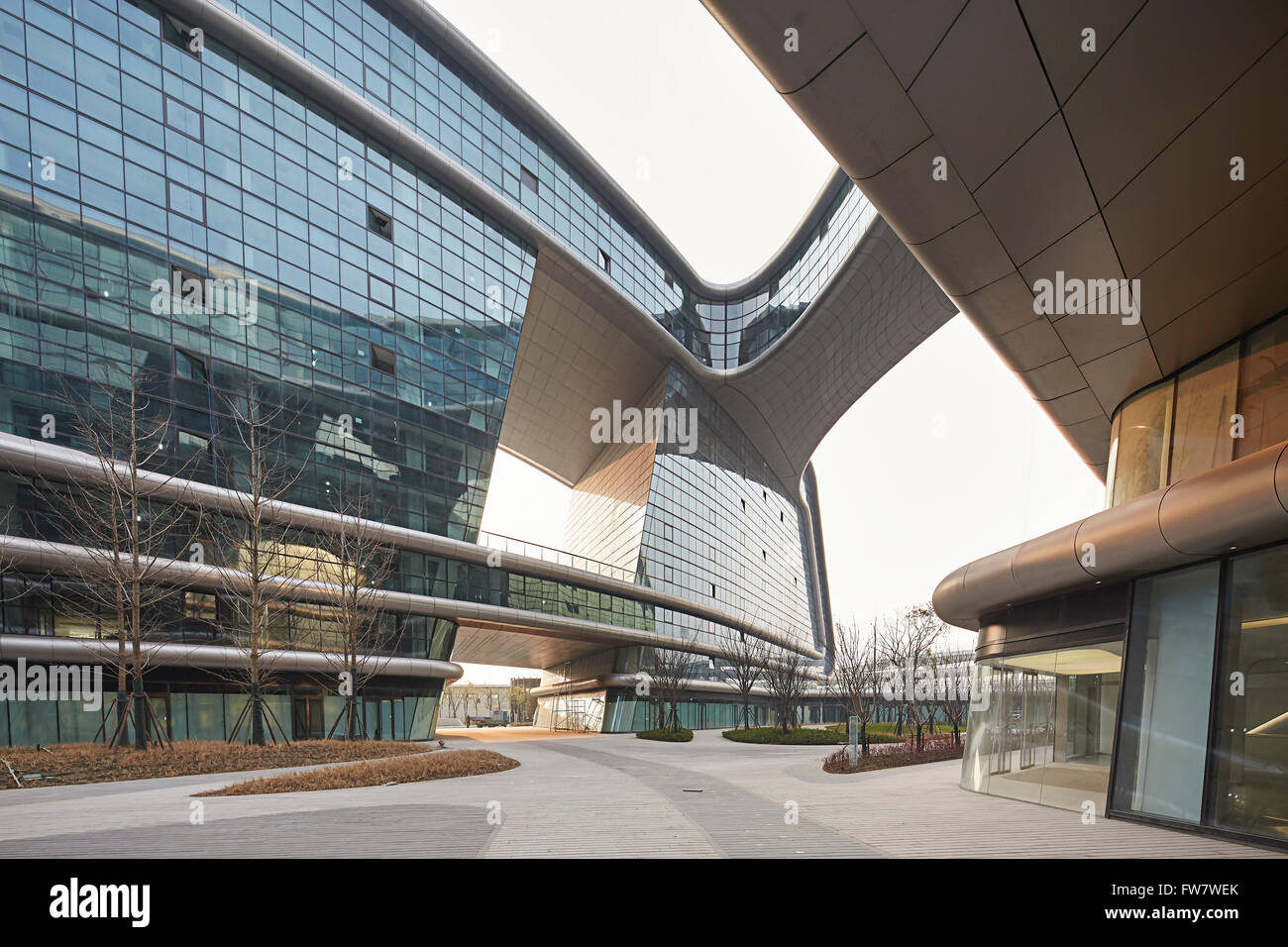 Exterior facade with landscaped walkways and bridge link. Sky SOHO ...