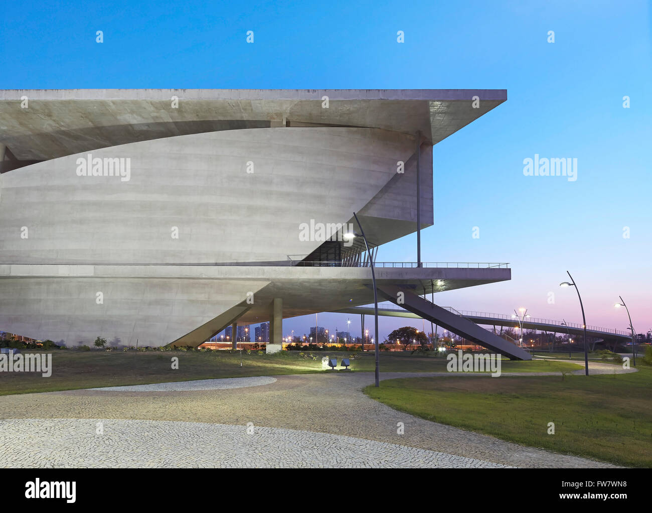 Partial facade elevation with cantilever balcony at dusk. La Cidade das ...