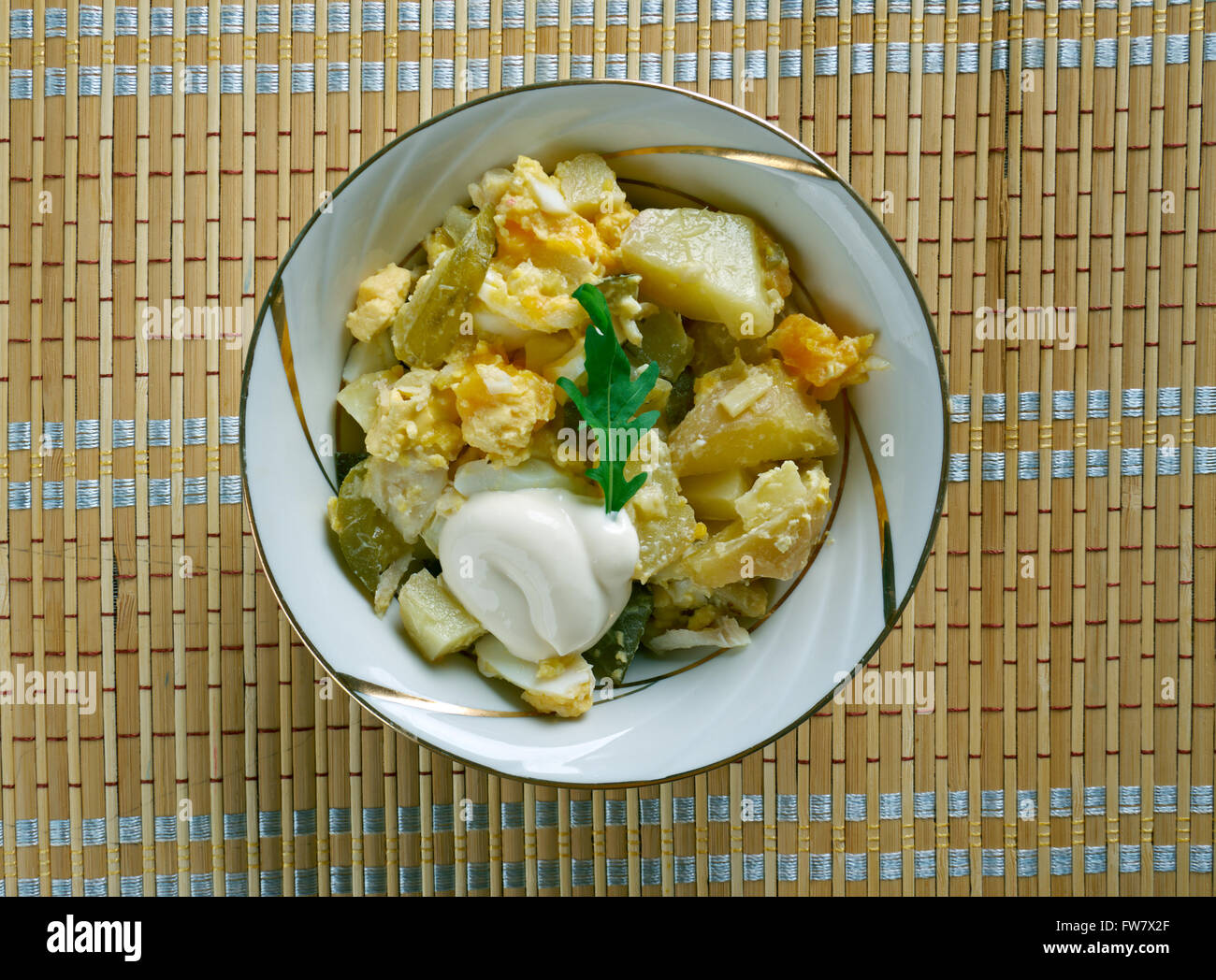 cod fish salad, pickled cucumber, egg and potatoes Stock Photo - Alamy