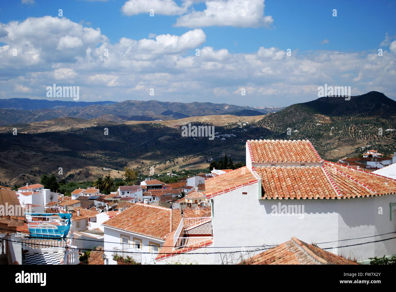 View over the village rooftops towards the mountains, Periana, Costa ...