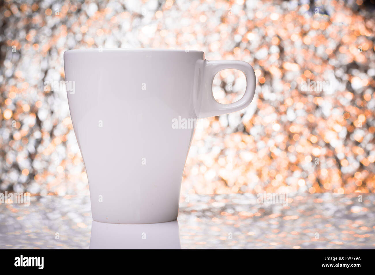 White tea cup on a color defocused background Stock Photo - Alamy