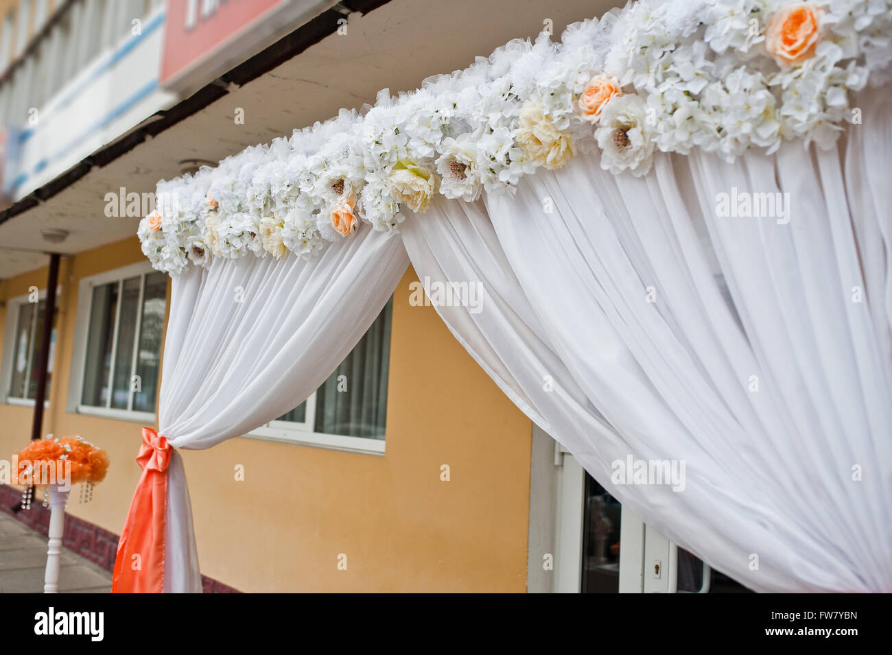 Decorative wedding arch with ribbons and flowers Stock Photo - Alamy