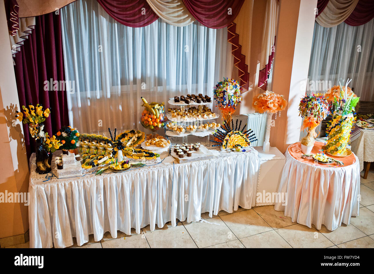 Wedding reception table of sweet candies and fruits Stock Photo - Alamy