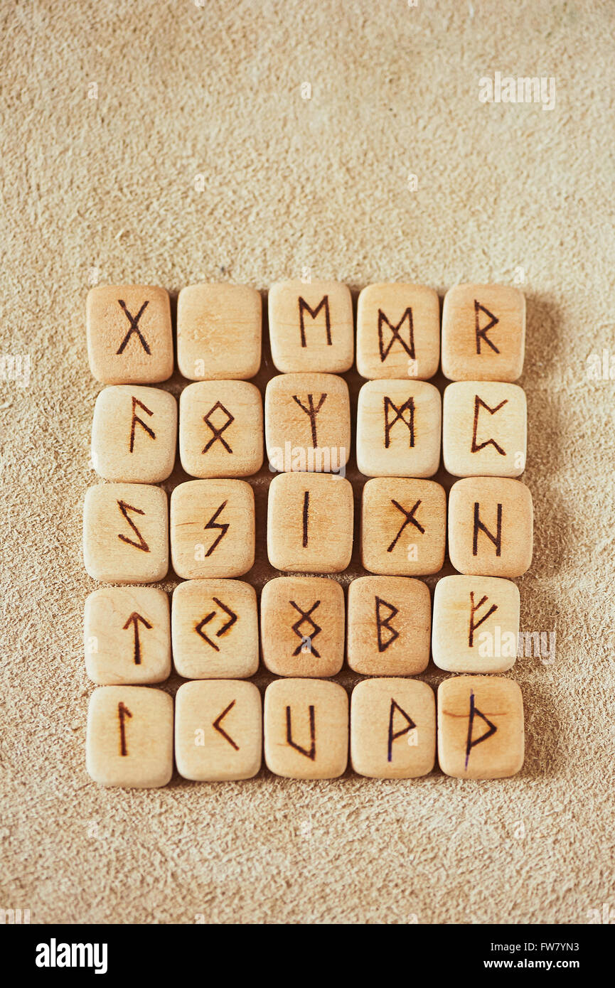 Rune on a background of rough suede mint Stock Photo - Alamy