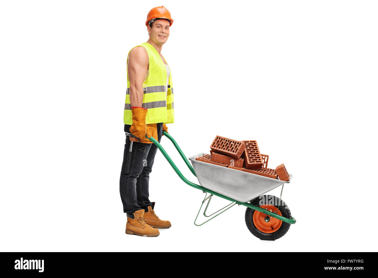 Construction worker posing with a wheelbarrow full of bricks isolated ...