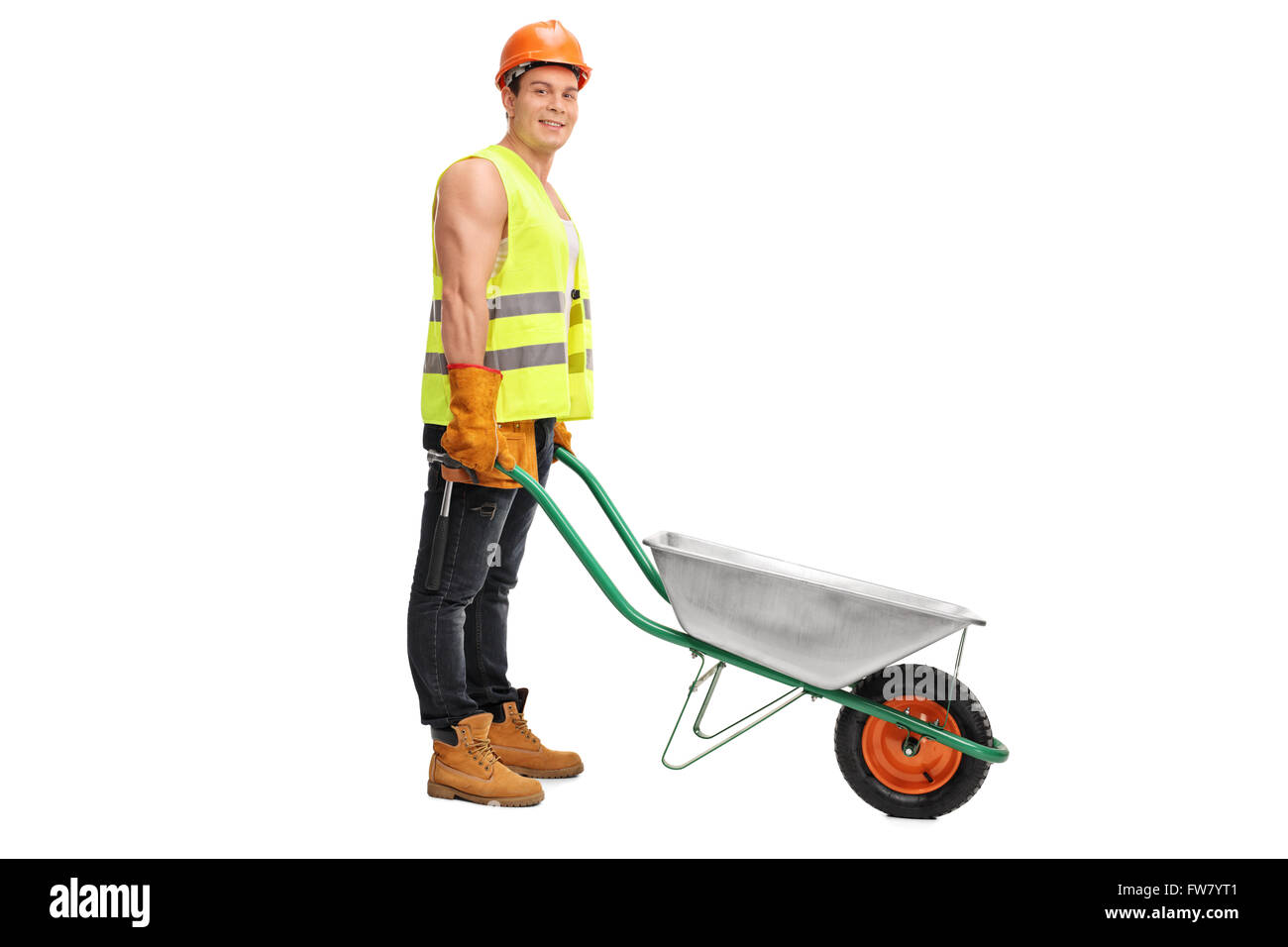 Construction worker posing with an empty wheelbarrow isolated on white ...
