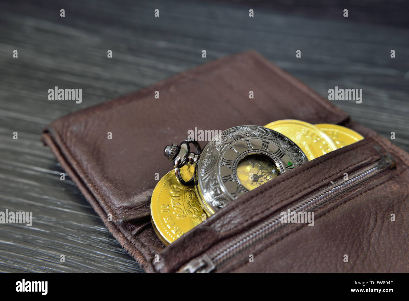 Pocket watch & money Stock Photo - Alamy