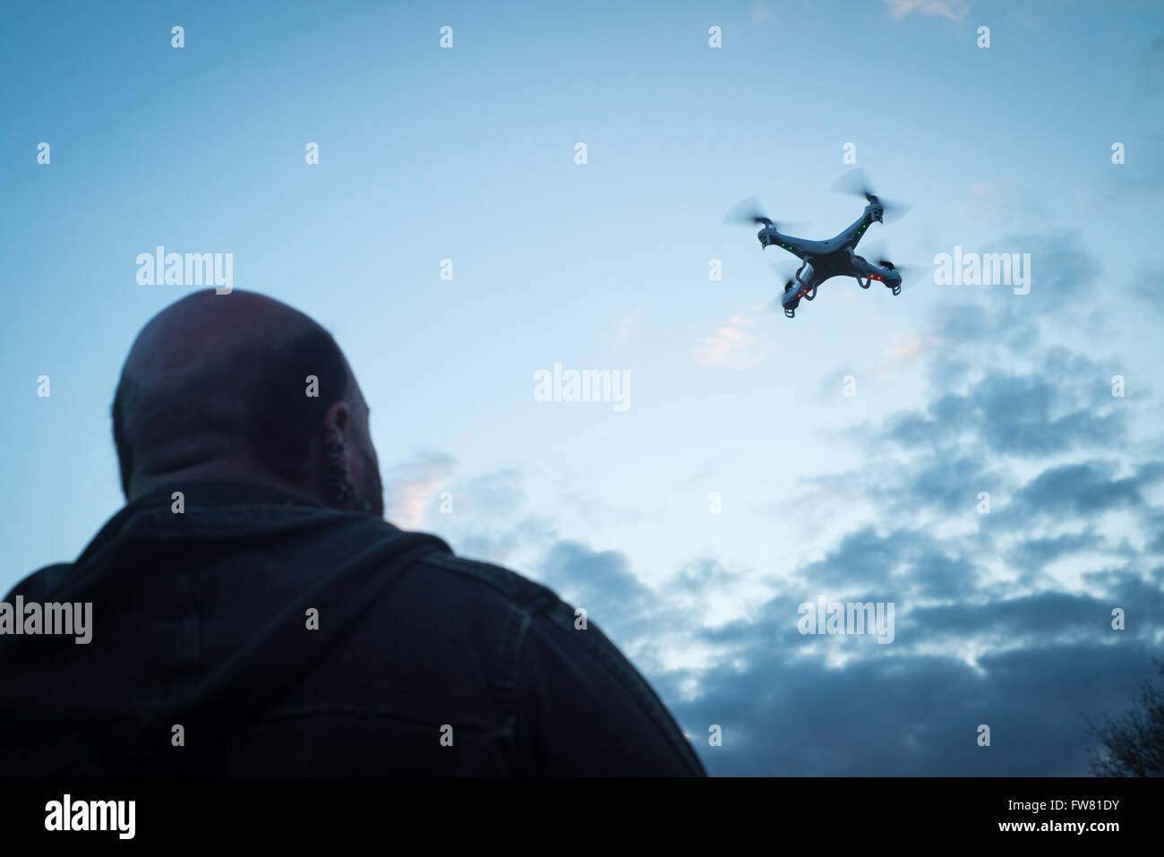 A man flies a quadcopter, or drone, in a park in Oxford, UK Stock Photo ...
