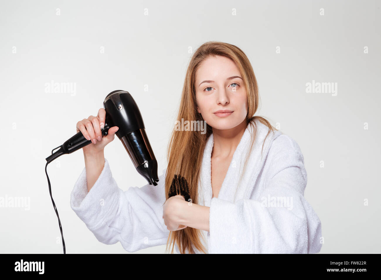 Beautiful woman drying her hair isolated on a white background Stock ...