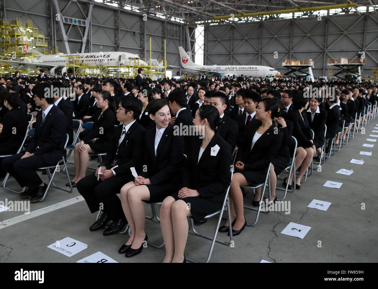 Tokyo, Japan. 1st Apr, 2016. Newly hired employees of Japan Airlines ...