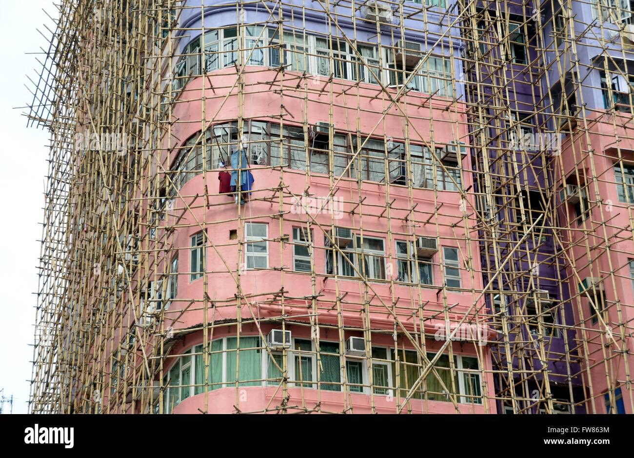 A building with bamboo scaffolding in Kowloon, Hong Kong. As bamboo is a lot cheaper than steel ...