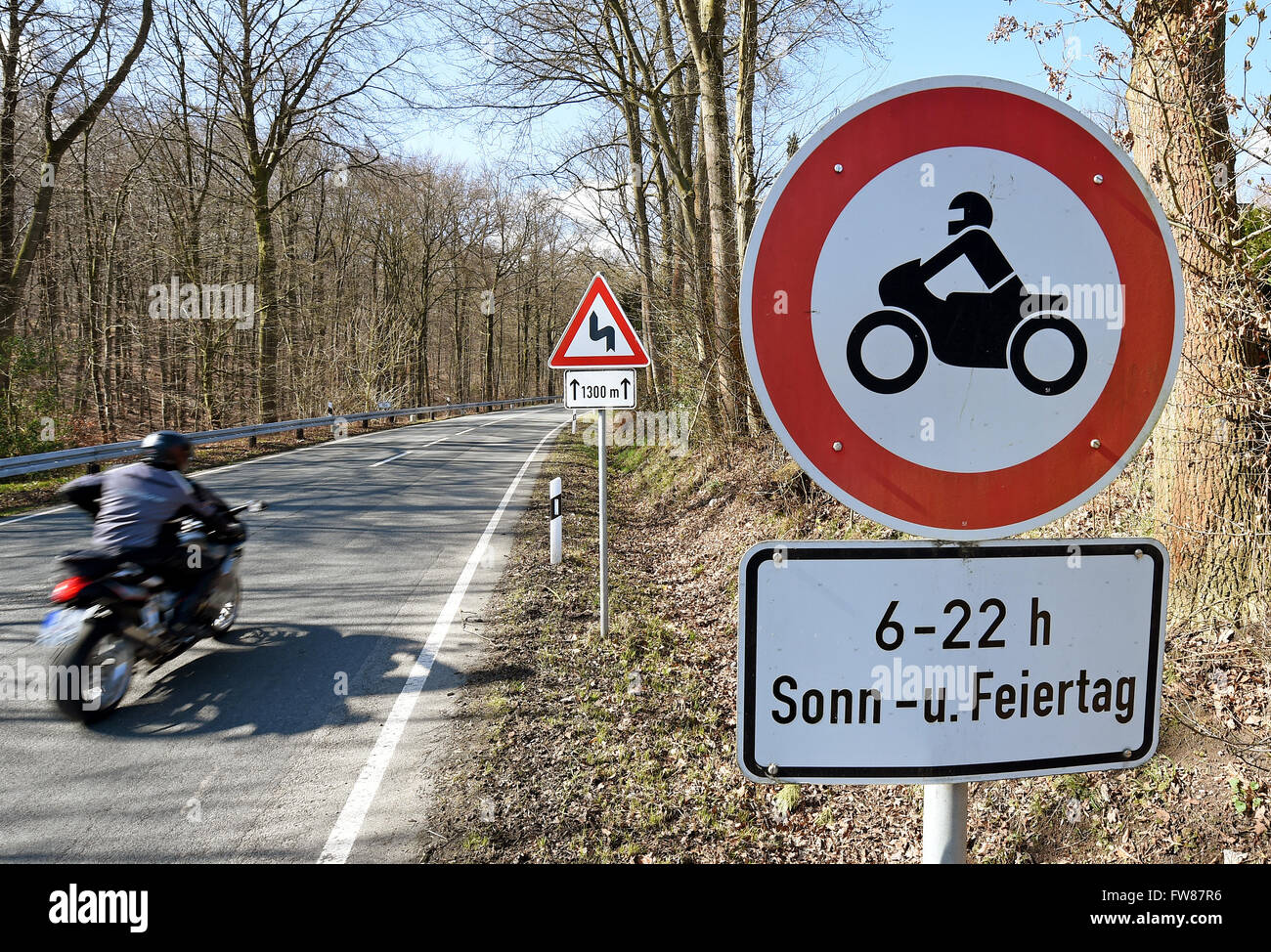 A motorcyclist rides past a prohibition sign on state road 401 between ...