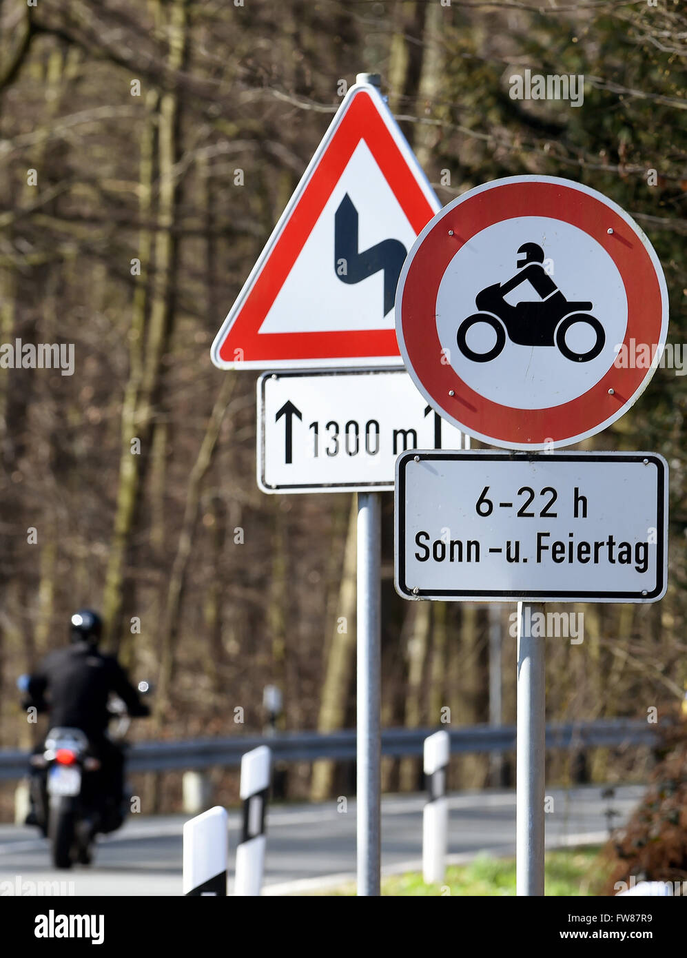 A motorcyclist rides past a prohibition sign on state road 401 between ...