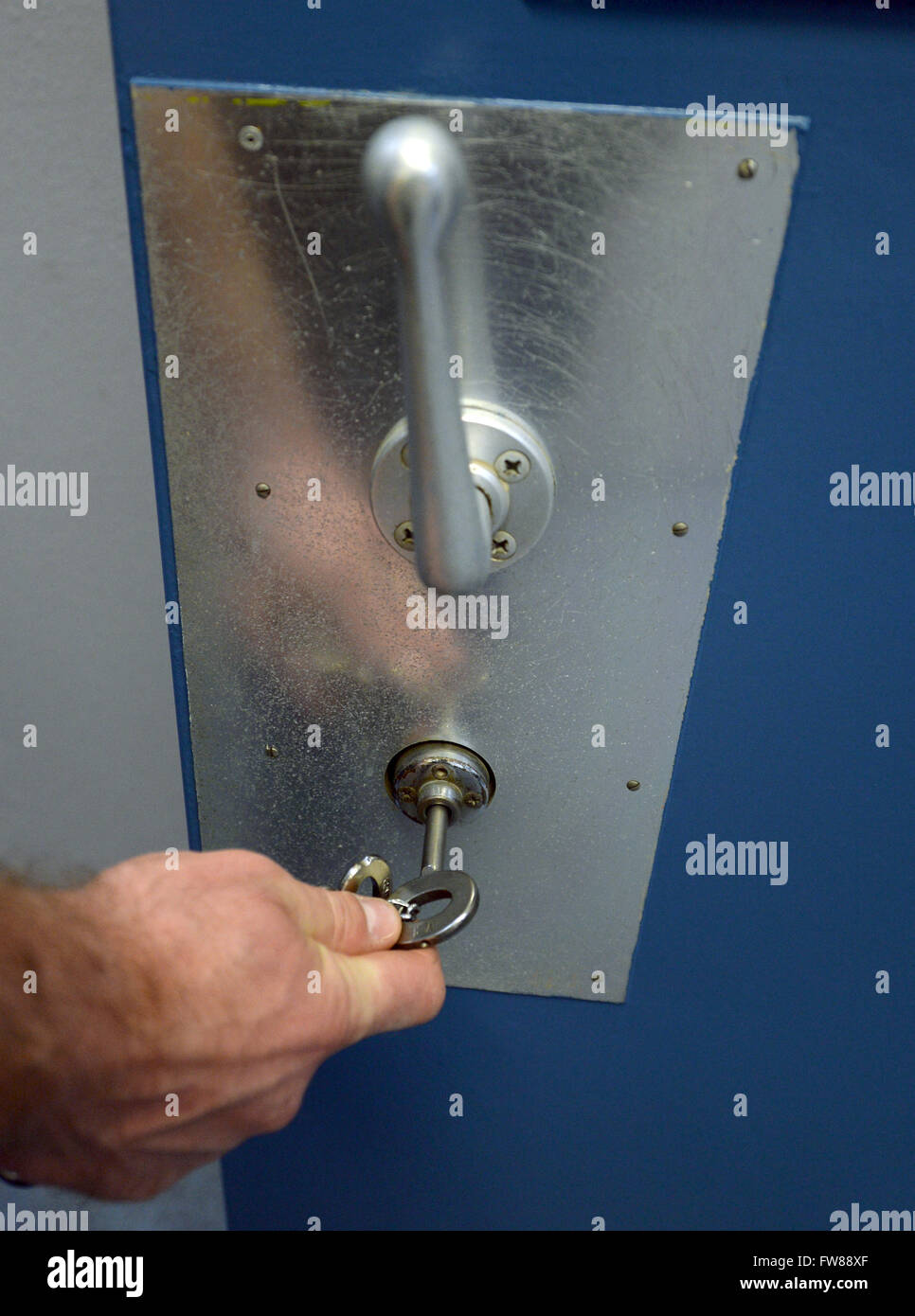 A prison officer locking a cell at the new deportation prison in ...